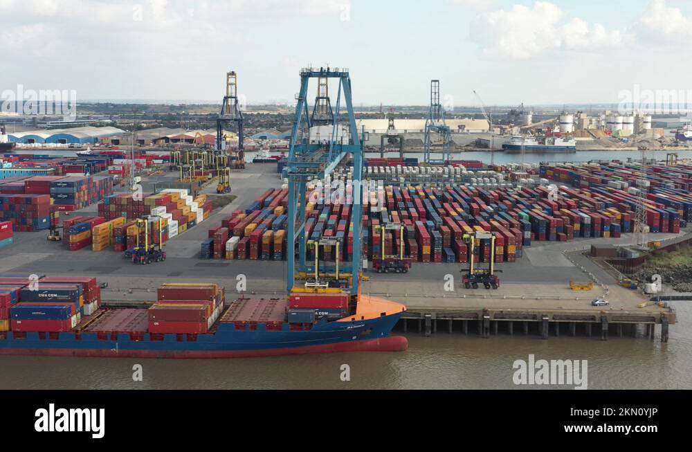 Cargo ship and stacked naval freight containers in harbour Stock Video ...