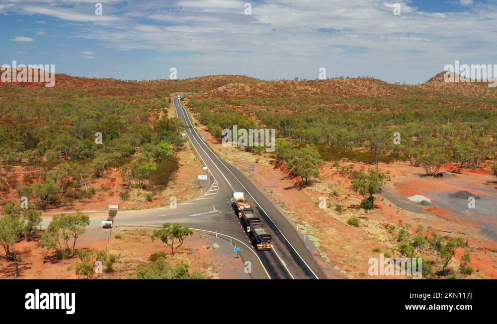Three-trailer Road Train In The Australian Outback Road On A Sunny Day ...