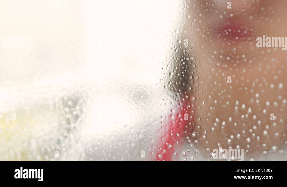 Female hands in yellow gloves cleaning window pane with rag and spray ...