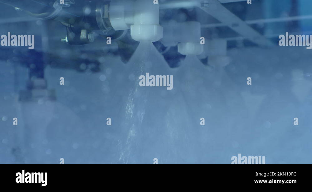 jets of clean, transparent water flow from pipes to the washing chamber ...