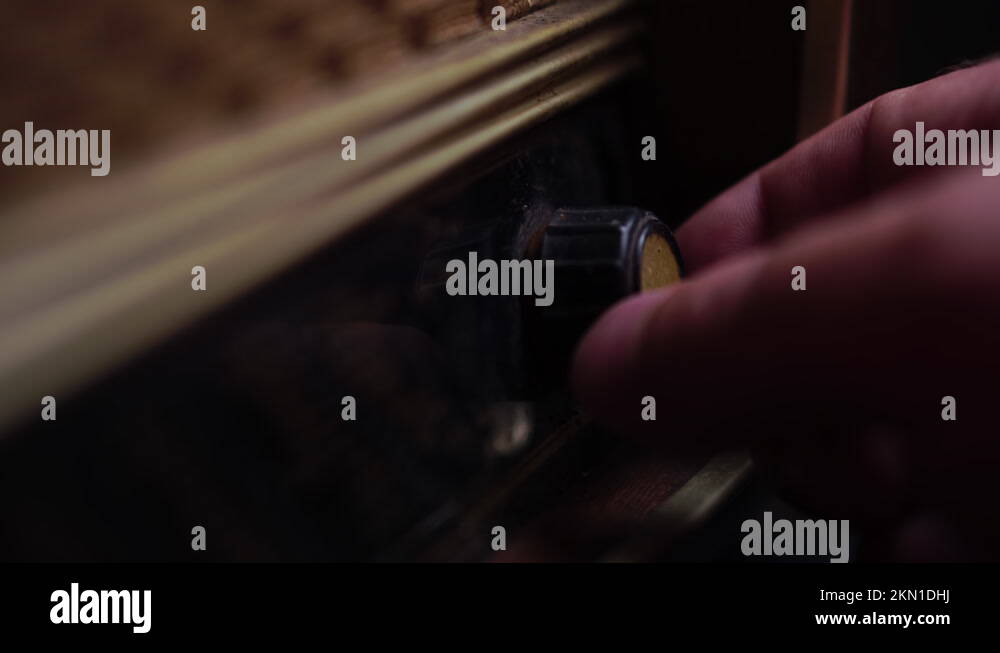 Hand on Tuning Wheel of Vintage Radio Station Receiver Searching For ...