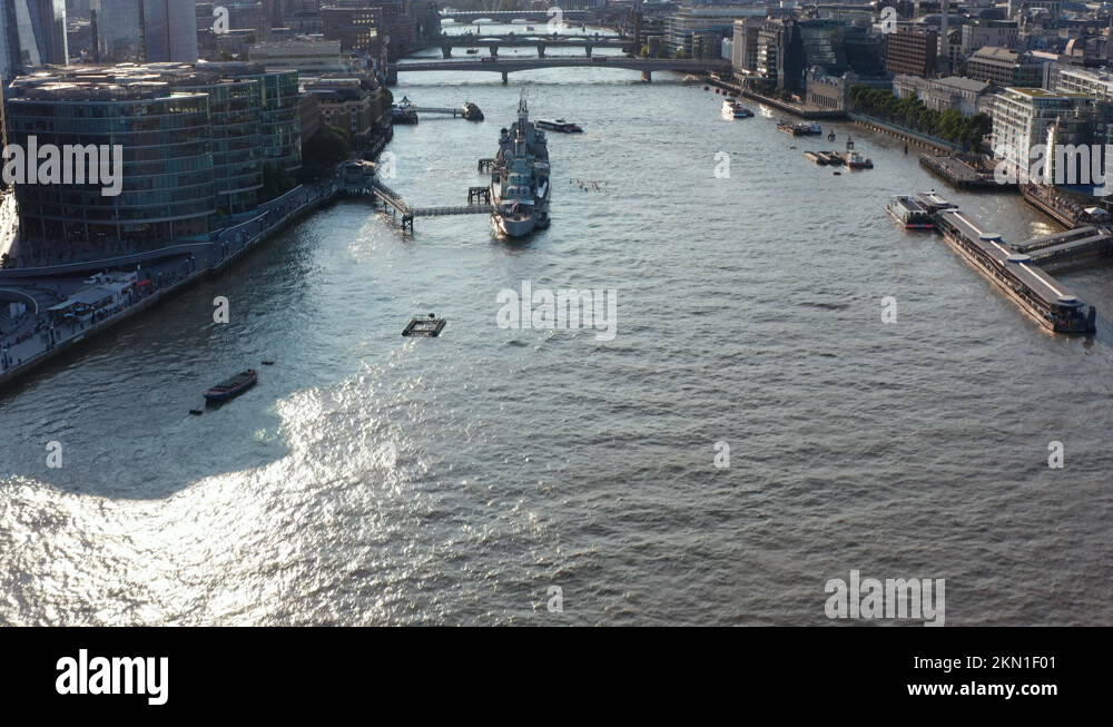 Fly over top walkway of Tower Bridge. Tilt up reveal of bridges across ...