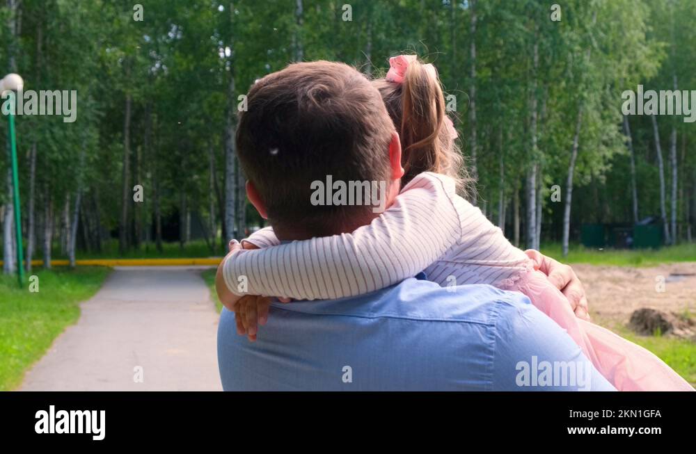 Happy father carrying around his neck and hugging daughter 4-5 years ...