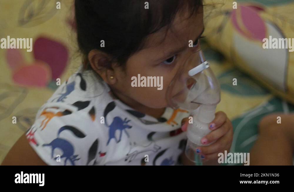 Little girl in a mask, treatments respiratory tract with a nebulizer at ...