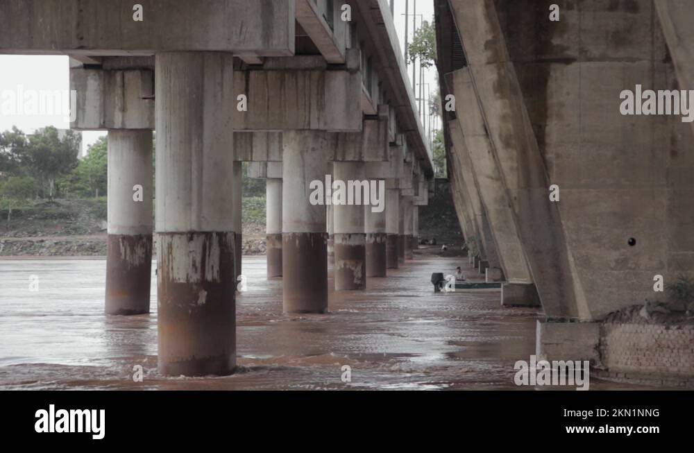 Wide Shot Of Concrete Pillars Of River Ravi Bridge, Boat Underneath In ...