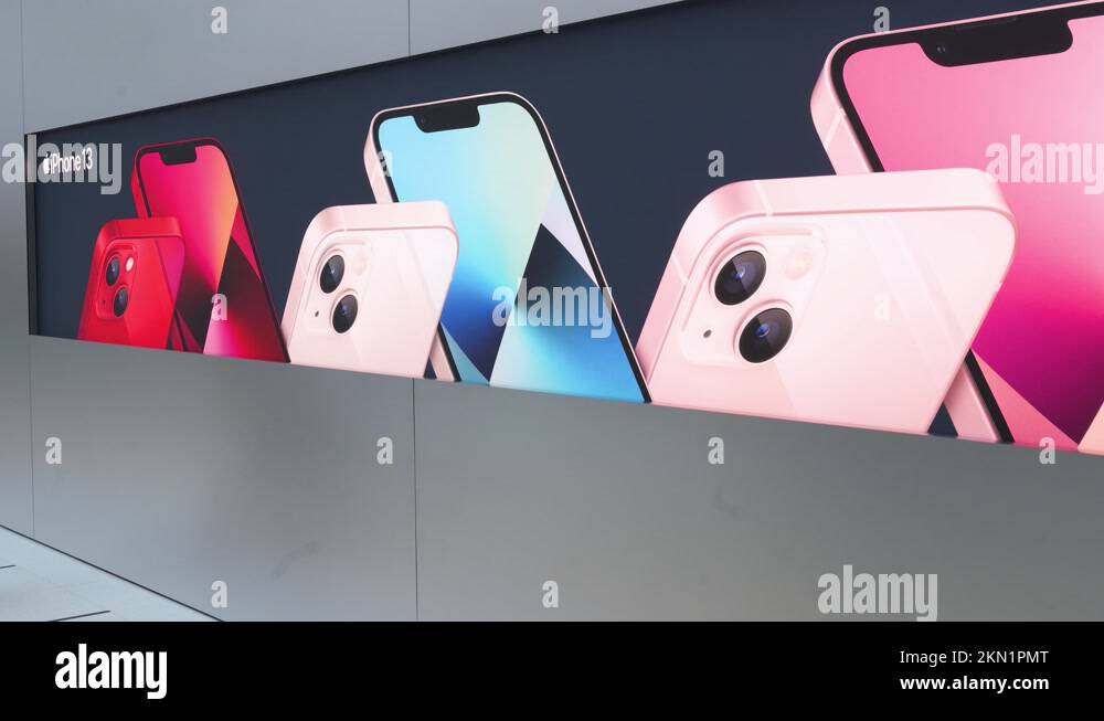 A customer walks past the Apple store after purchasing the iPhone 13 ...