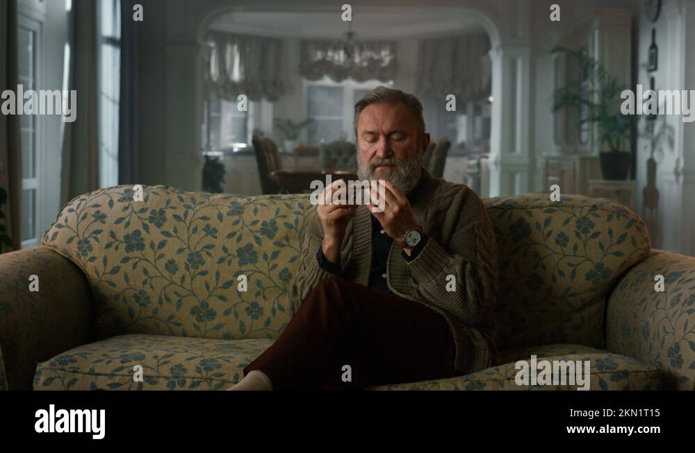 Relaxed senior gentleman smelling cuban cigar. Rich old man relaxing ...