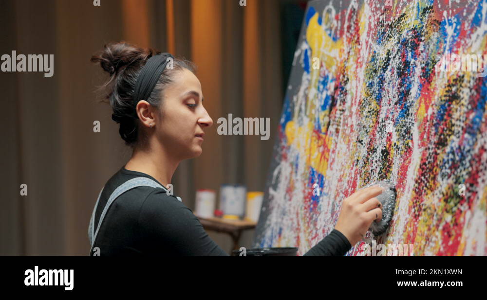 Art student spends time at university in painting studio, completing ...