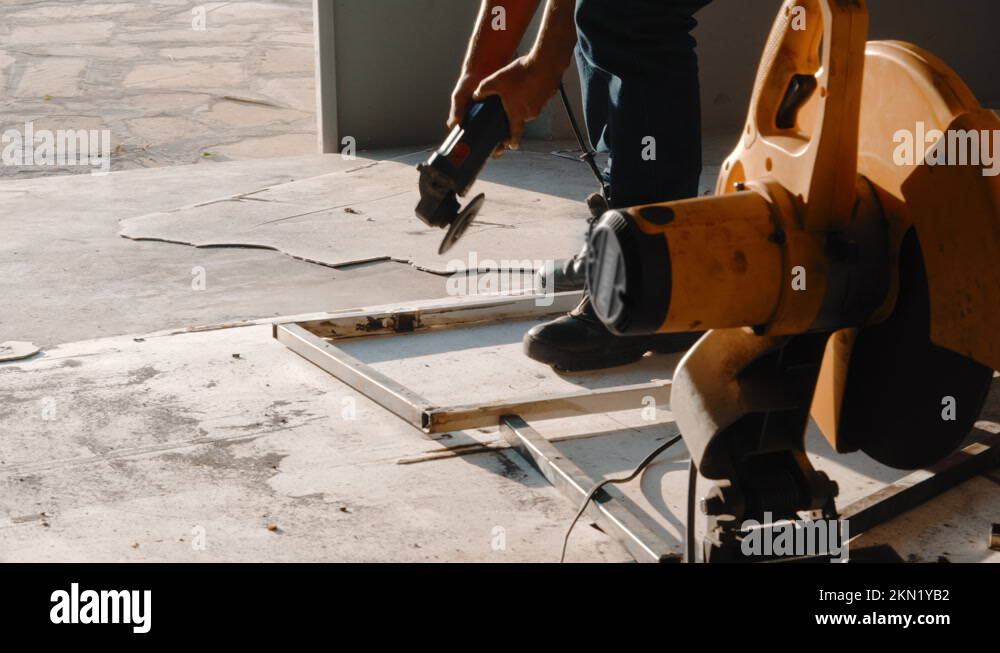 Blacksmith Polishing Metal Frame With A Grinder, Working Next To A Cut ...