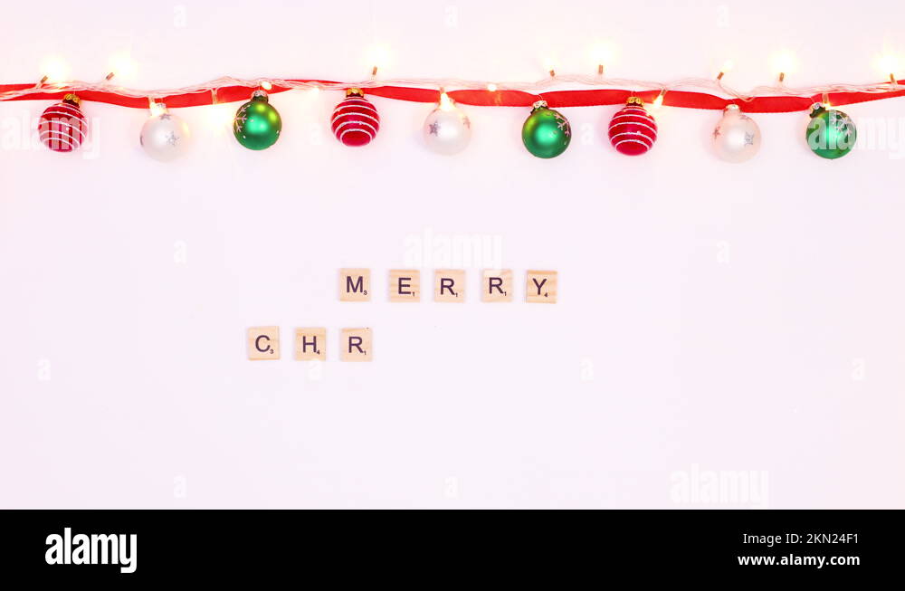Merry Christmas text appear under red ribbon with hanged balls. Stop ...