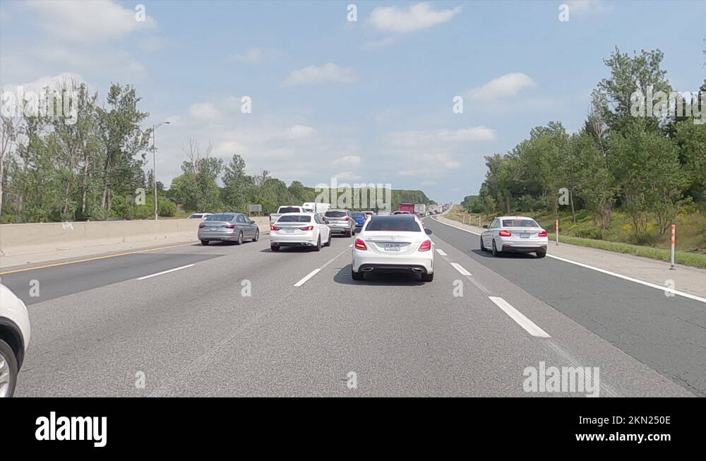 Driving plate of POV highway with blue sky nice day with cars and truck ...