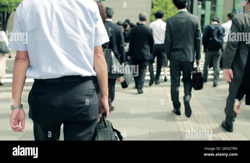 A crowd of a businessmen heading to work in the morning Stock Video ...