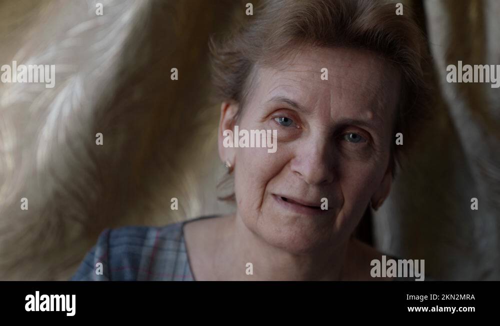 old woman with teeth problem, looking at camera and smiling toothless ...