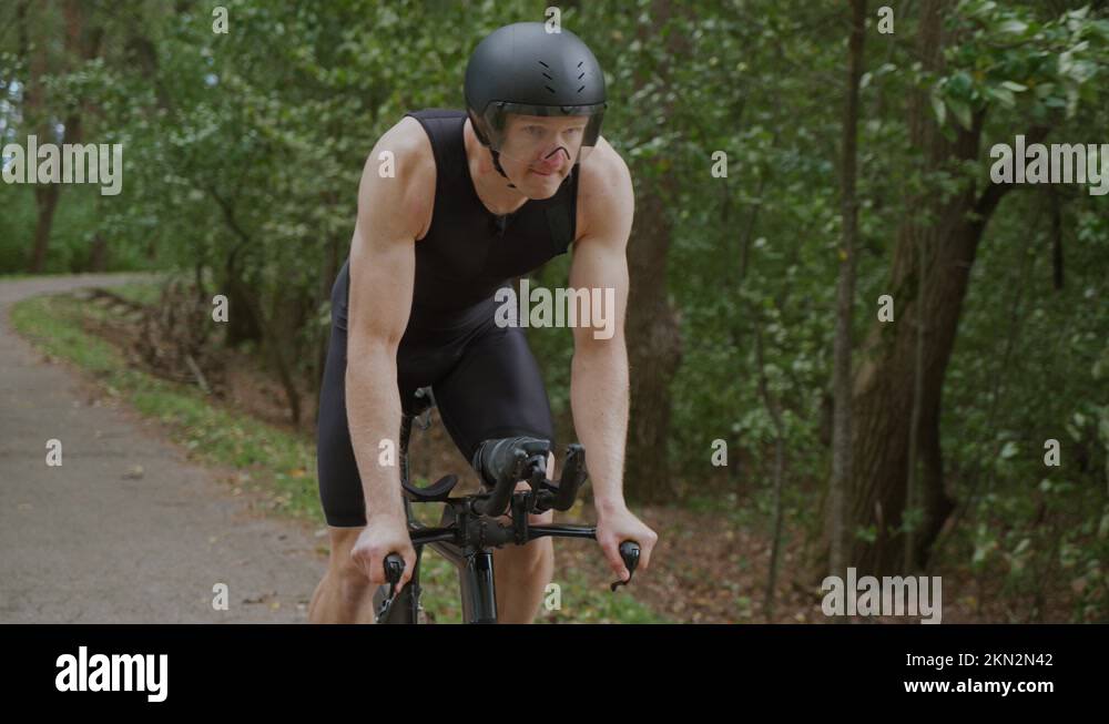 Super slow motion, Triathlete rides a bike, pro cyclist rides on a ...