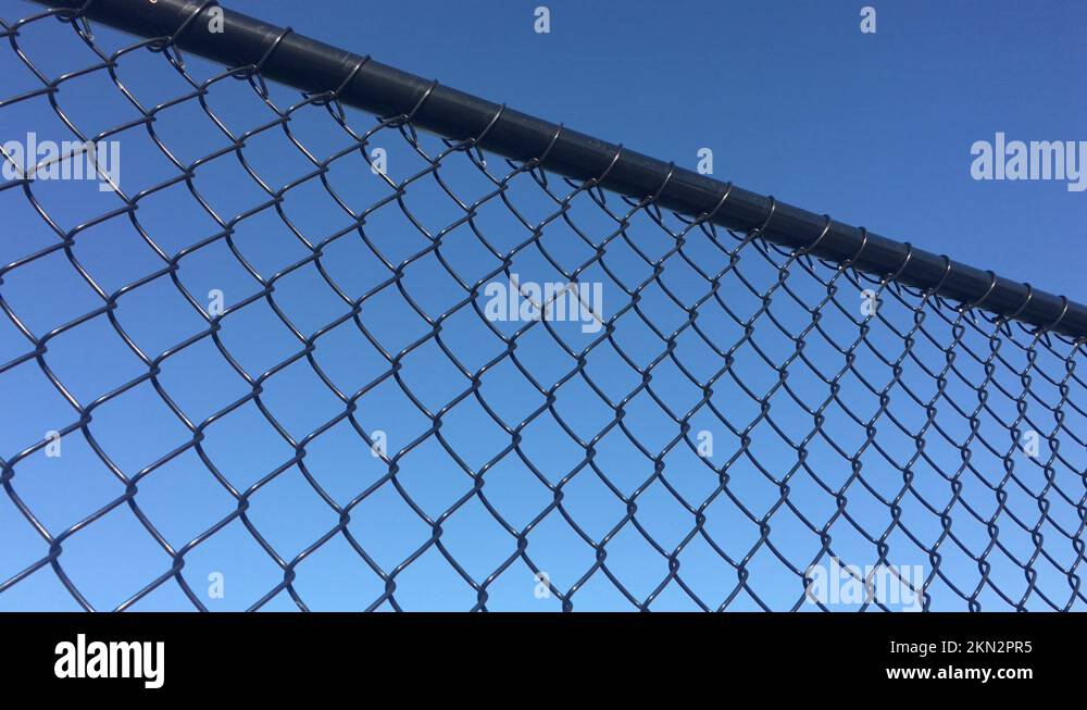 Cyclone chain wire mesh fencing background Stock Video Footage - Alamy