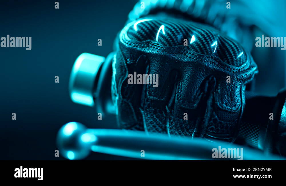 Camera statically captures drivers hand in leather gloves on road who ...