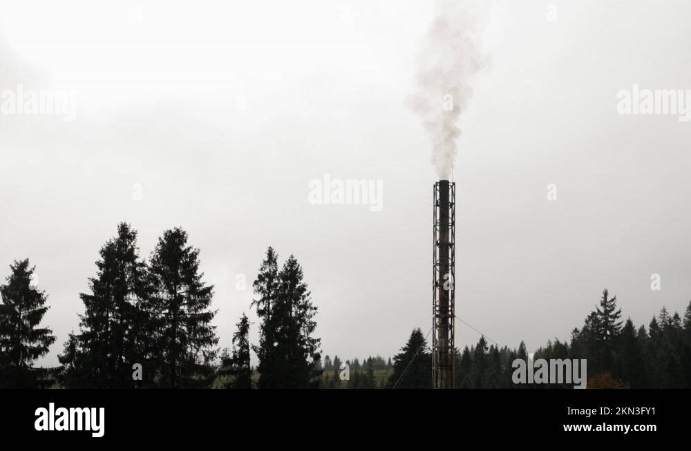 High pipe with black smoke. Plant smoke stack. Waste recovery burning ...