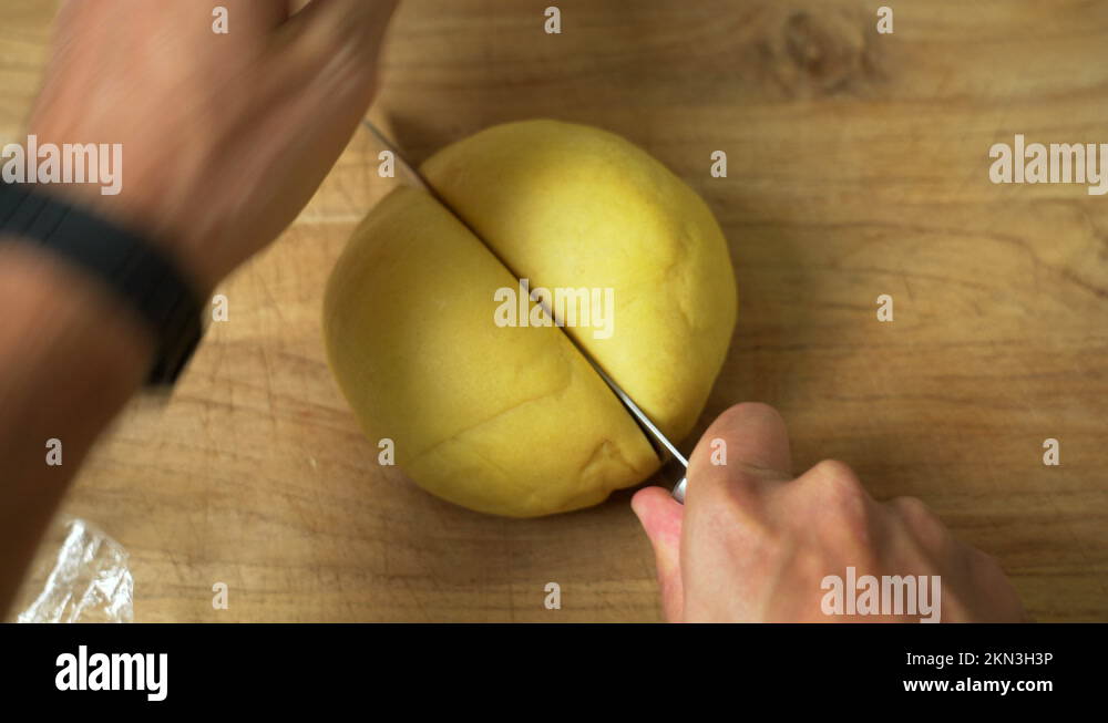Dividing a ball of fresh egg pasta into 4 pieces. Italian food making ...