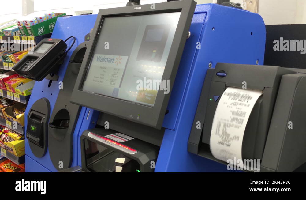 The motion of man taking the receipt at self-checkout counter inside ...