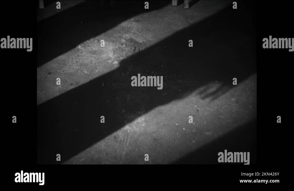 1950s: Flames. Shadows file past a row of caskets. Mourners file past ...
