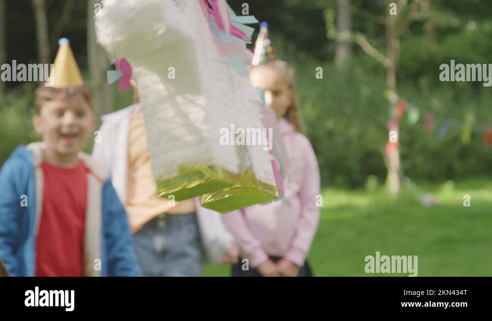 Handheld Shot of Young Girl Hitting Pinata at Birthday Party 01 Stock ...