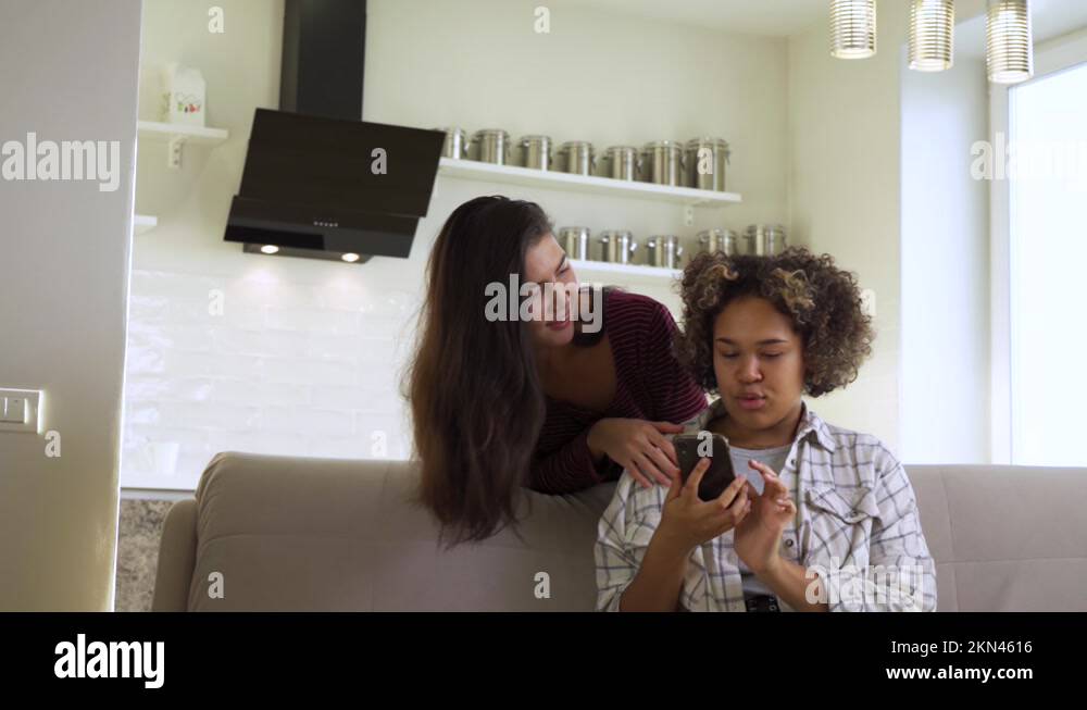 Two friends communicate with each other with smiles. African American ...