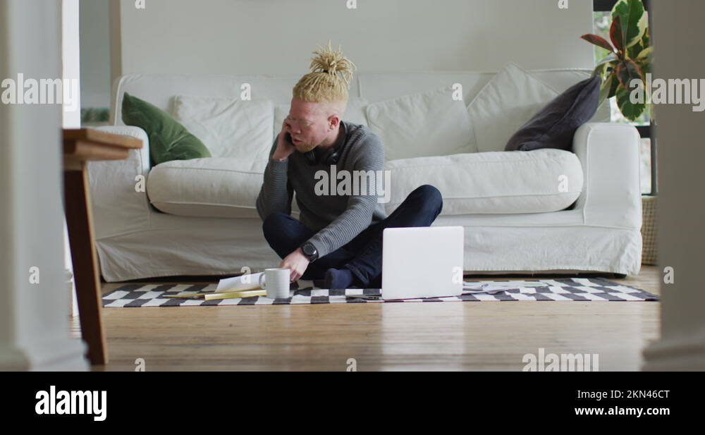 Albino african american man with dreadlocks siting on the floor ...
