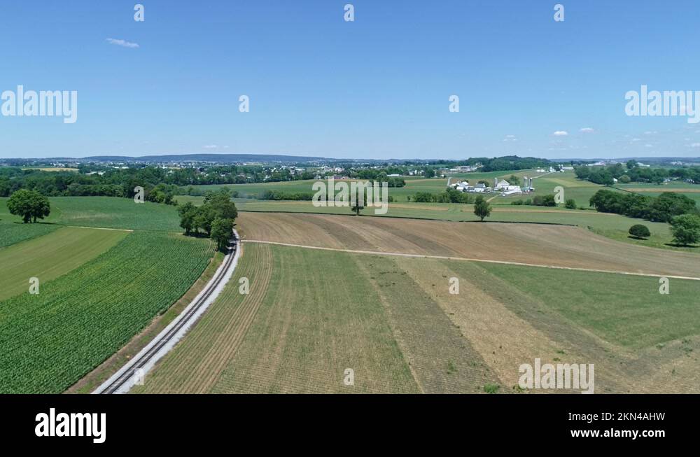 An Aerial View of the Farm Countryside with a Single Rail Road Track on ...