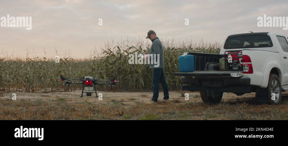 Huge intelligent agriculture drone with spray nozzles taking off near ...