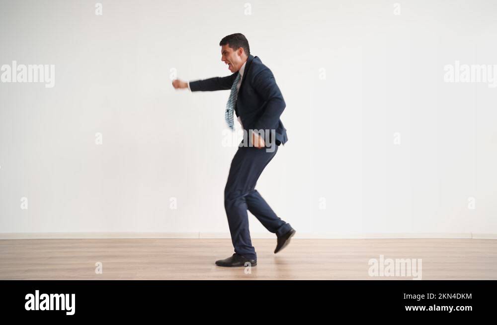Funny business man dancing for joy and success on a white background ...