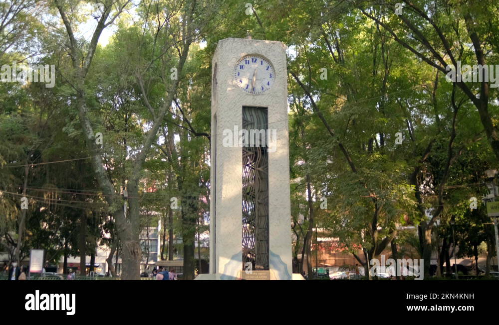 Small clock tower with trees and bright sunlight as background Stock ...