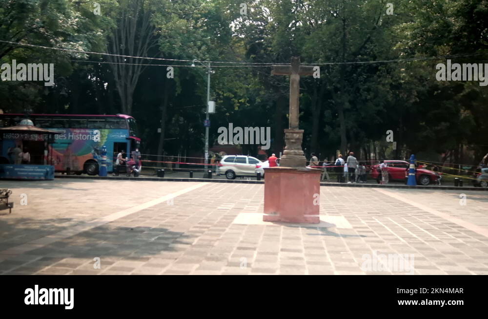 Stone cross statue in peaceful park from Coyoacan, Mexico City Stock ...