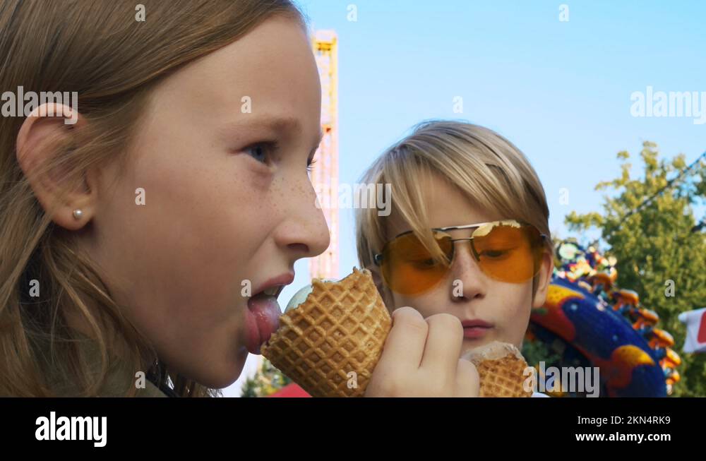 A Teenage Girl Licks A Delicious Ball Of Ice Cream With Her Tongue
