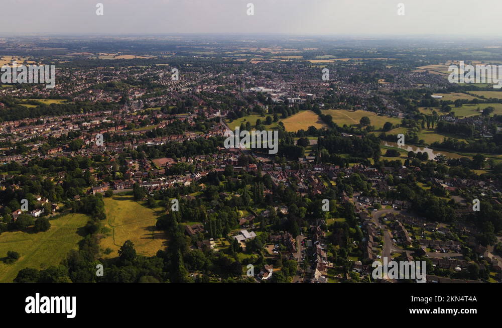 Ariel landscape of town in England. Rooftops, houses, park, and green ...