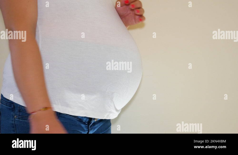 Mother touch her belly while waiting for baby, static side view Stock ...