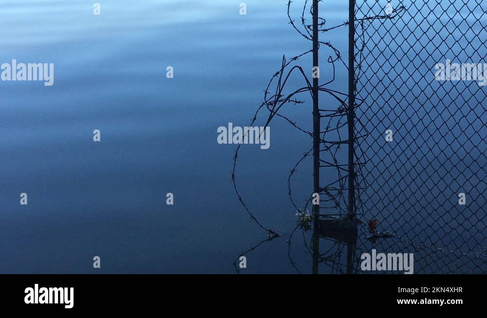Old mesh and barbed wire to prevent escape on the water surface ...
