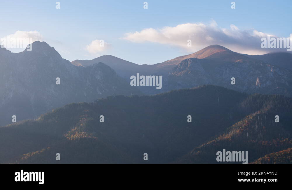 Time lapse peaks mountain ranges covered with rolling clouds in morning ...