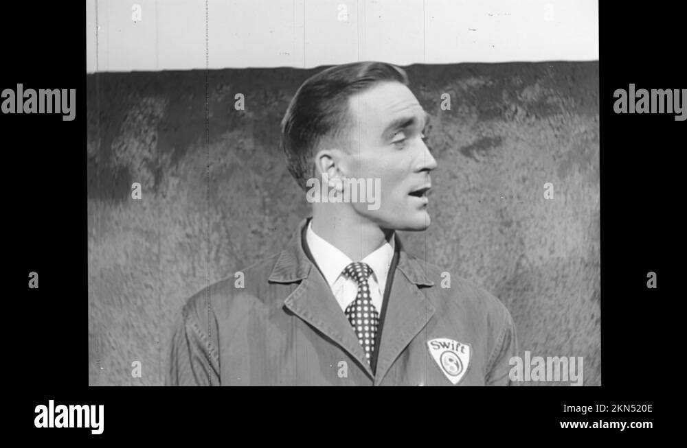 1950s: Man on balcony of office building talks. Man talks back. Two men ...