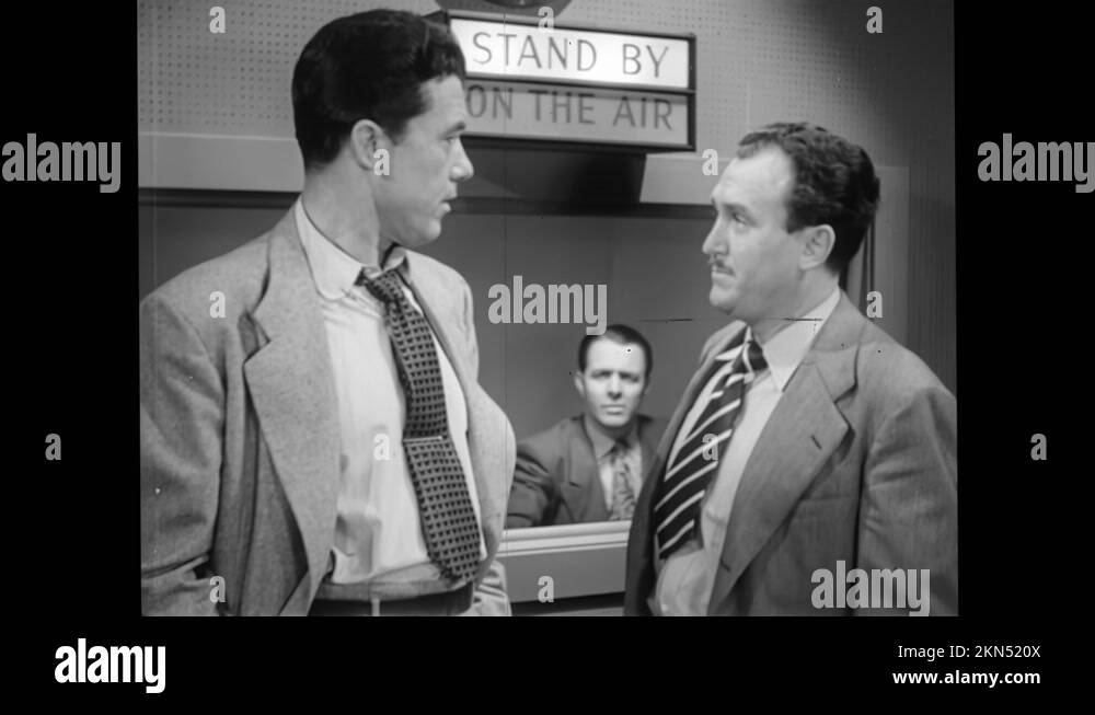1950s: Two men have conversation in radio broadcast booth. Man enters ...