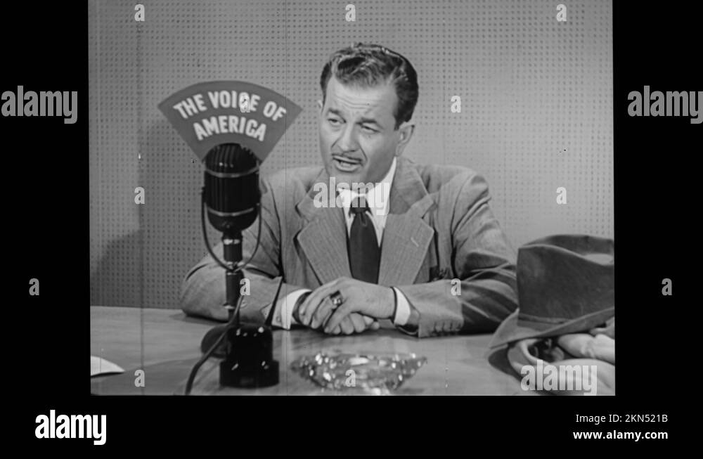 1950s: Man in radio broadcast booth talks into microphone Stock Video ...