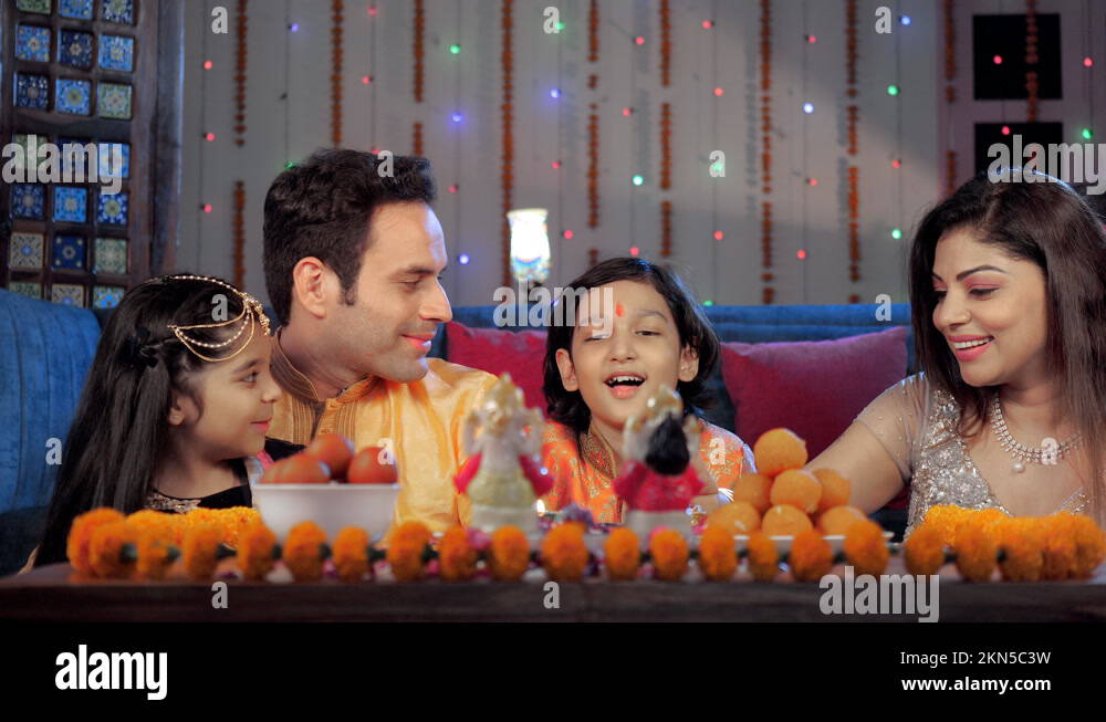 An Indian woman putting a red Tika for all the family members after ...