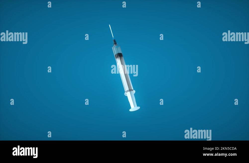 The syringe, partially filled with medication, rotates around its axis ...