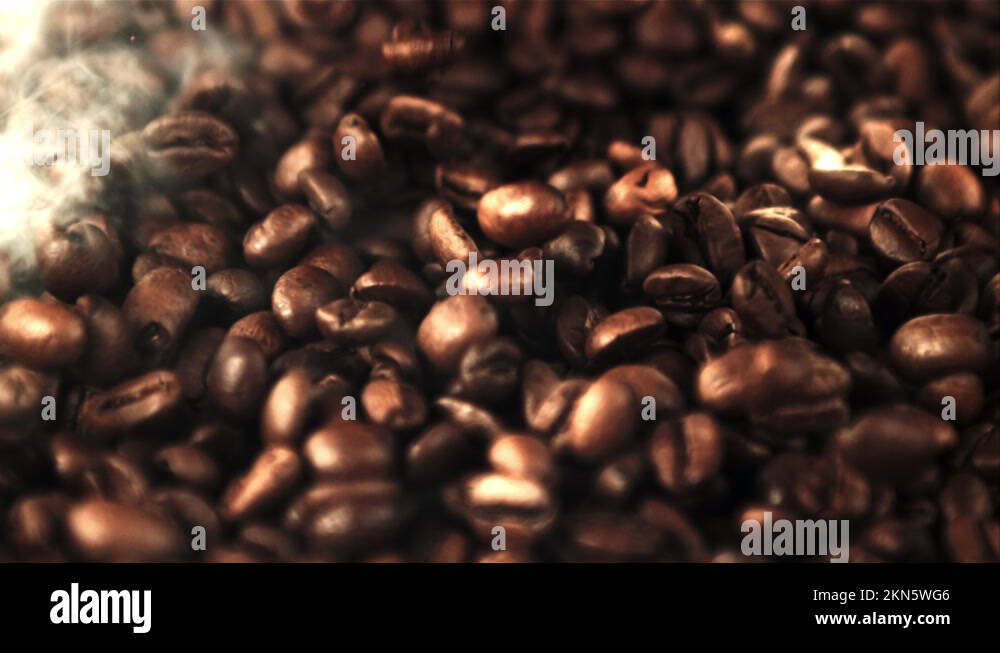 Super slow motion coffee beans fall with hot steam. Filmed on a high ...