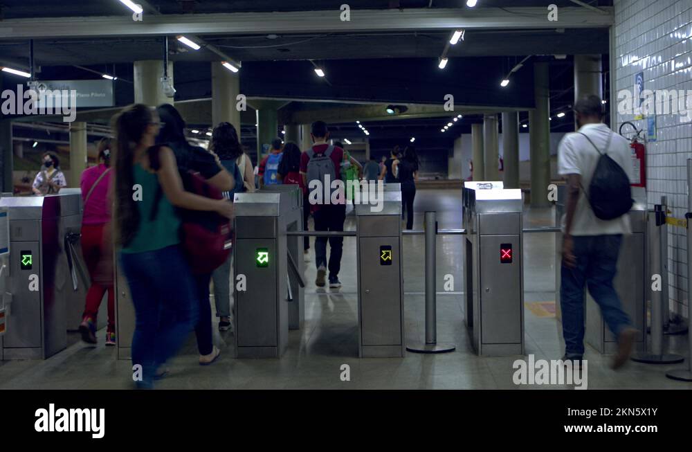 Passengers enter the ticket turnstile to ride the metro train Stock ...