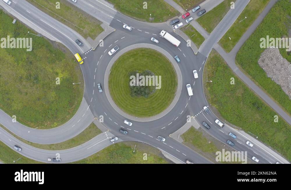 Cars driving in and out of a roundabout Stock Video Footage - Alamy