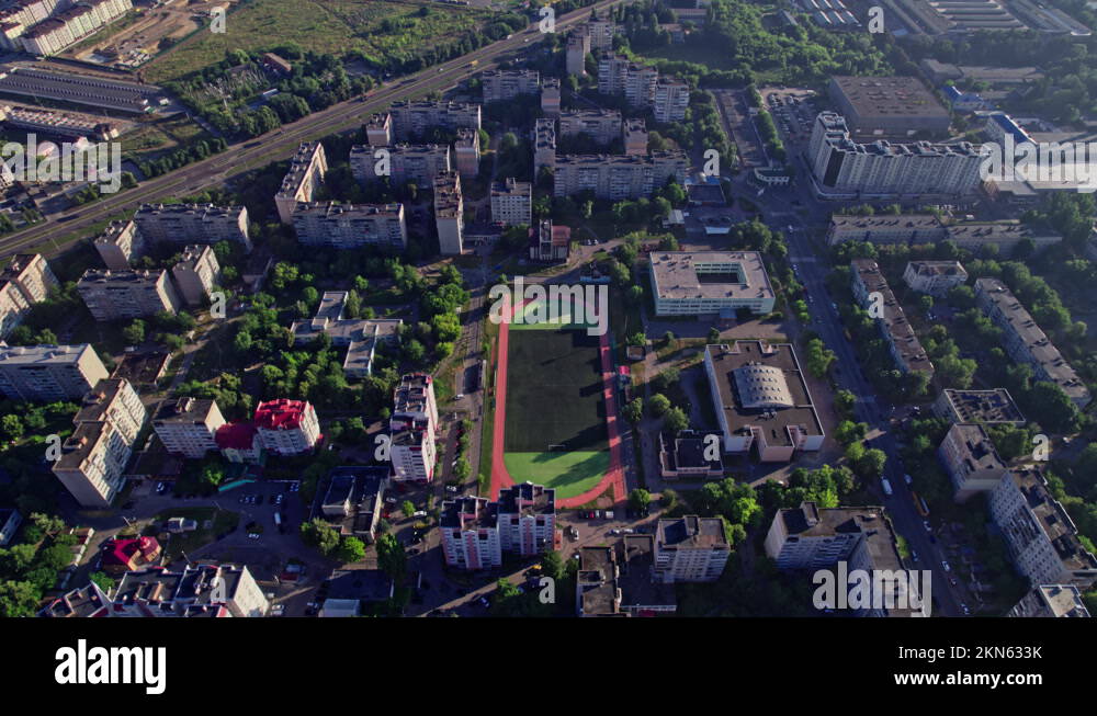 Buildings with street in small town with empty football soccer field ...