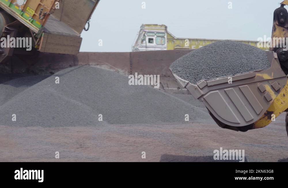 Bulldozer moving coal to a pile at a mine in Paradip Port, Orissa ...