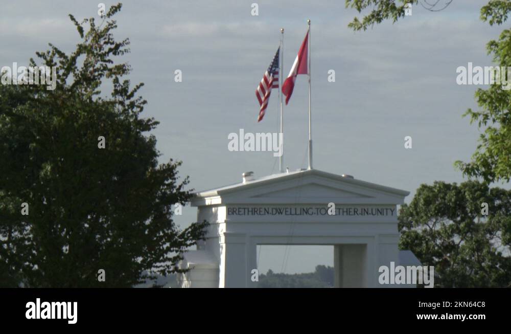 Various shots of U.S and Canadian flags waving at the Peace Arch Border ...