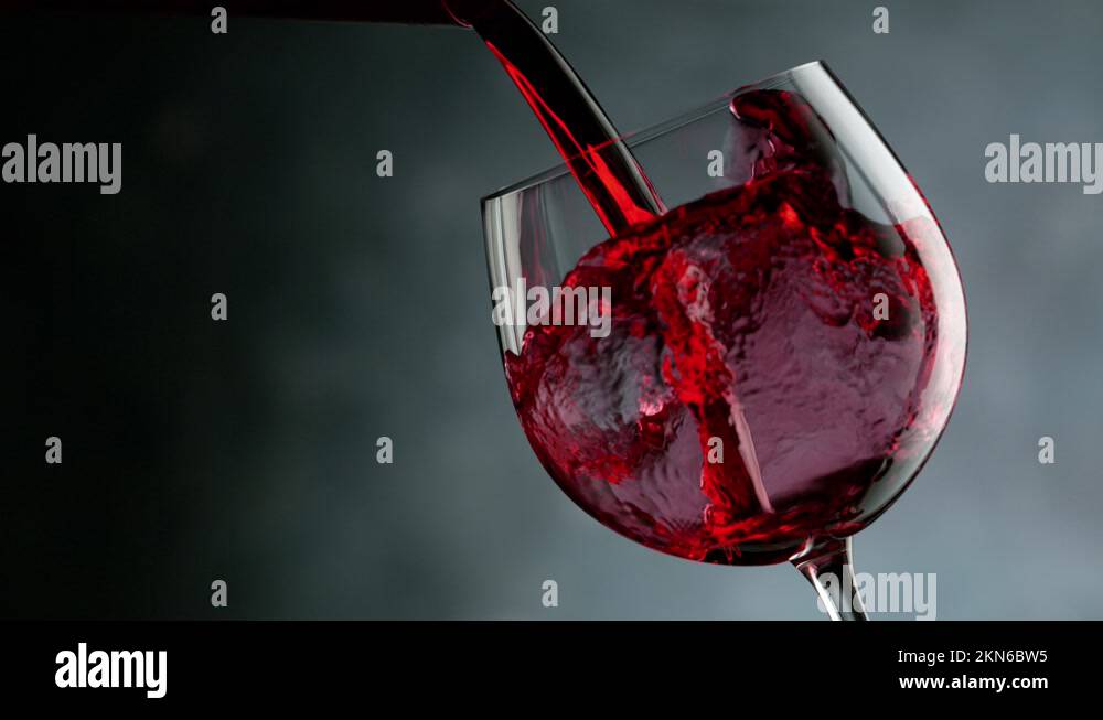 Super slow motion of pouring red wine into glass in detail, speed ramp ...