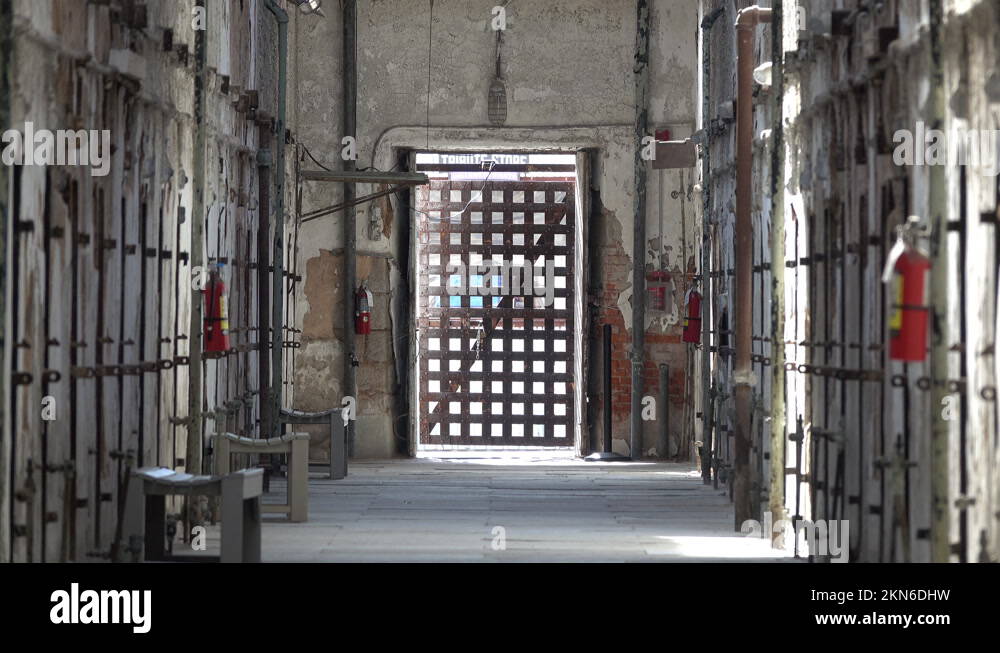 Barred door and fire extinguishers in penitentiary cell block Stock ...